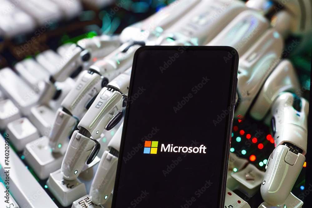 A robotic hand, embodying artificial intelligence, types on a computer ...