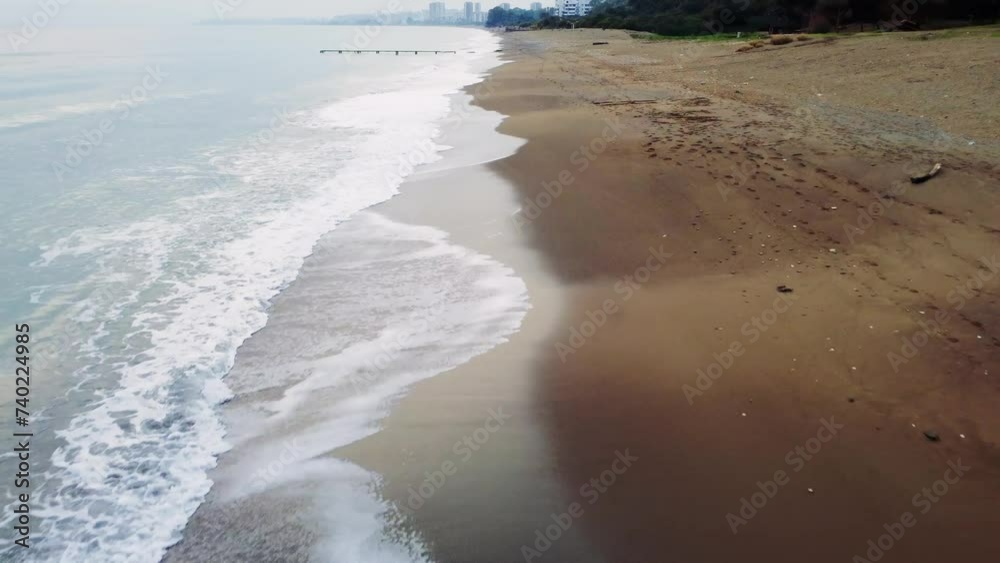 Vidéo Stock Low drone flight along surf line of sandy beach. Coastal ...
