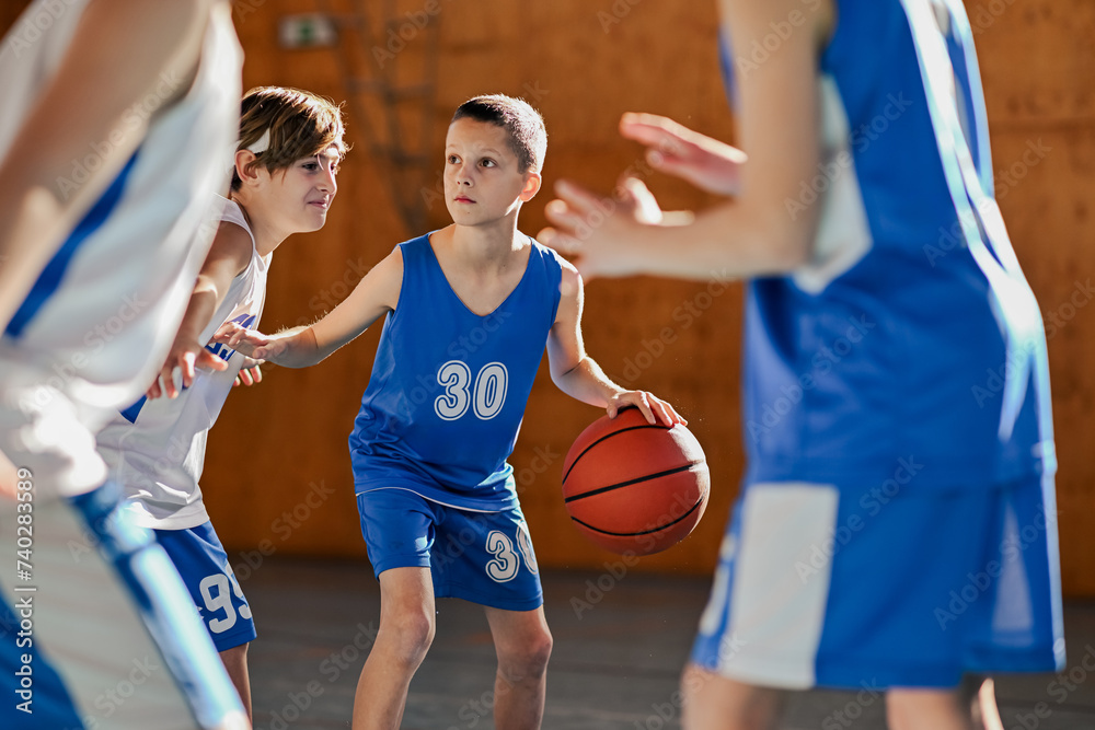 Basketball kid is dribbling and guarding a ball during training with ...