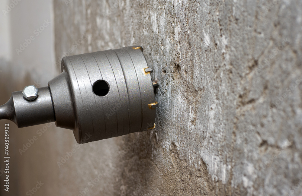 Installation of sockets in the house. A hammer drill with a drill for ...