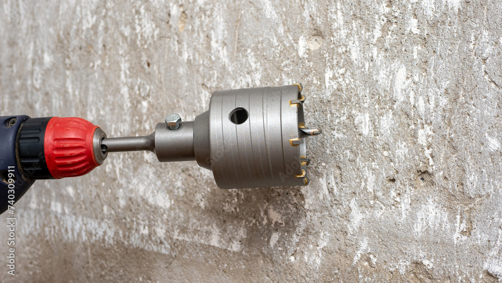 Installation of sockets in the house. A hammer drill with a drill for ...