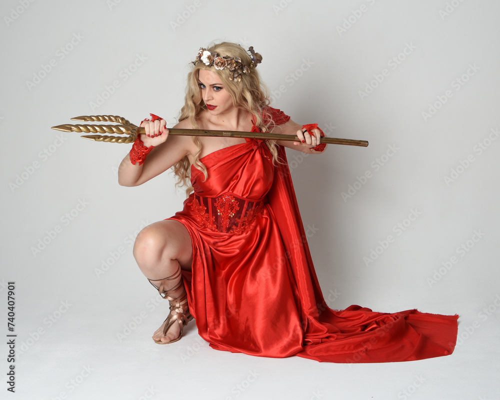 Full length portrait of beautiful blonde model dressed as ancient ...
