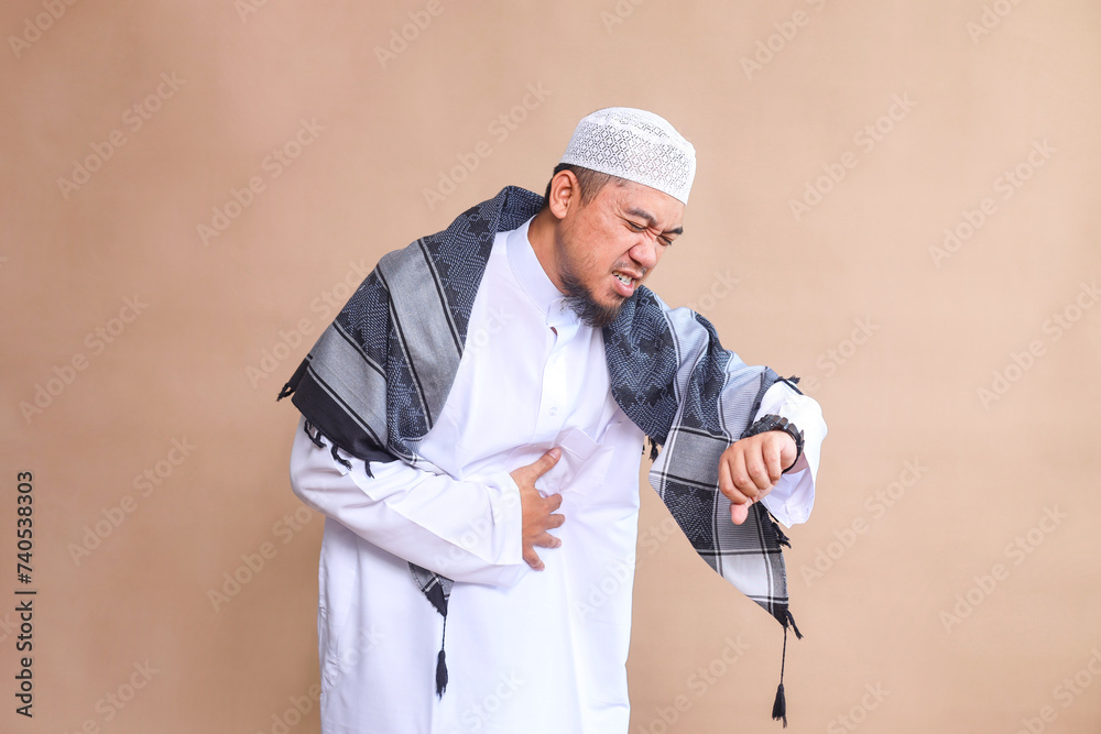 Asian Male Wearing Muslim Clothes Feeling Hungry, Touching Stomache ...