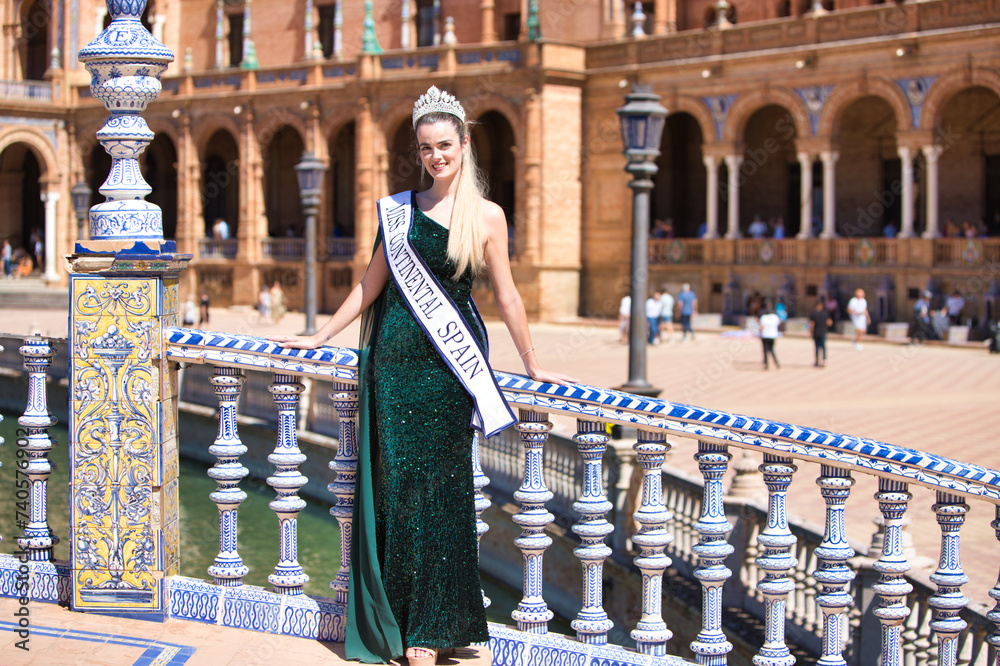 Beautiful young woman winner of a beauty pageant dressed in a green ...