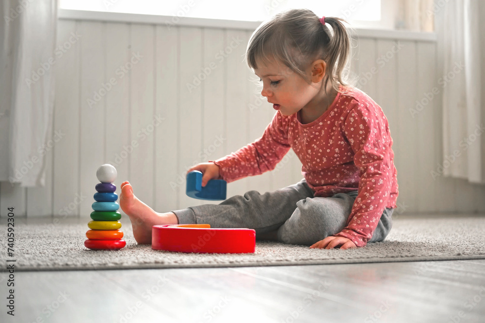 Kid girl play toys at home, kindergarten or nursery. Baby child playing ...