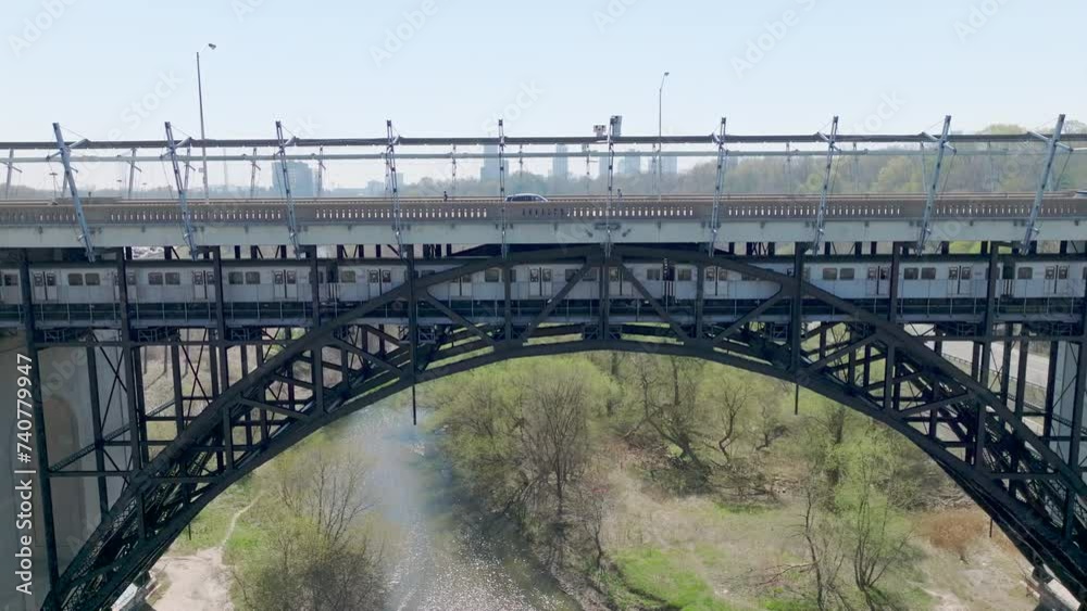 Overhead view of a multi-level bridge with moving train, vehicles, and ...