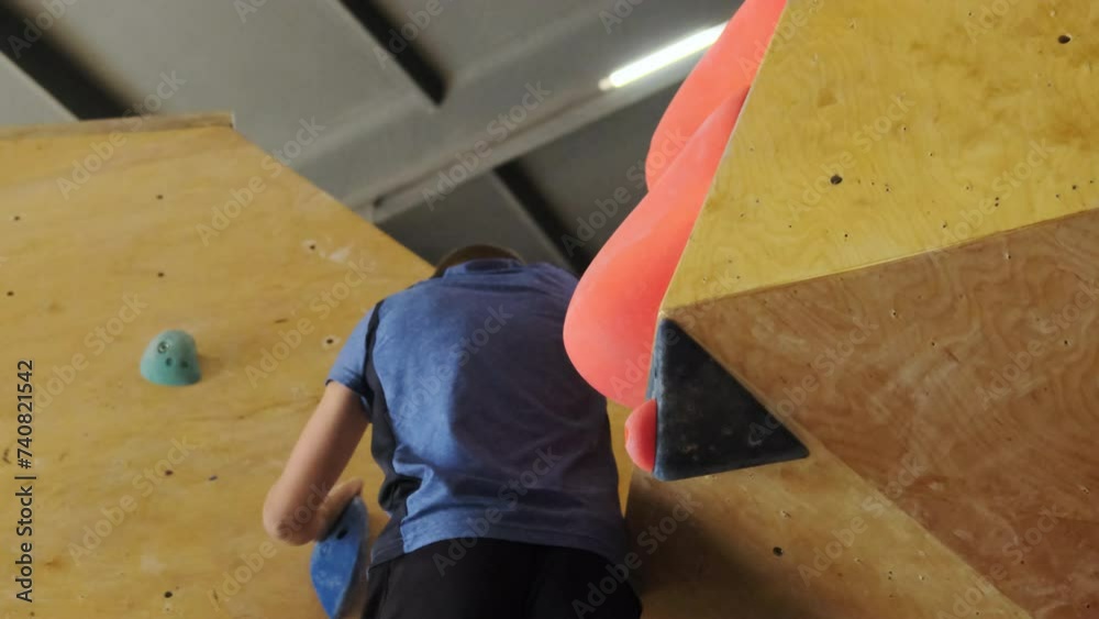 Boy shows ability to adapt and find best route on climbing wall. Child ...