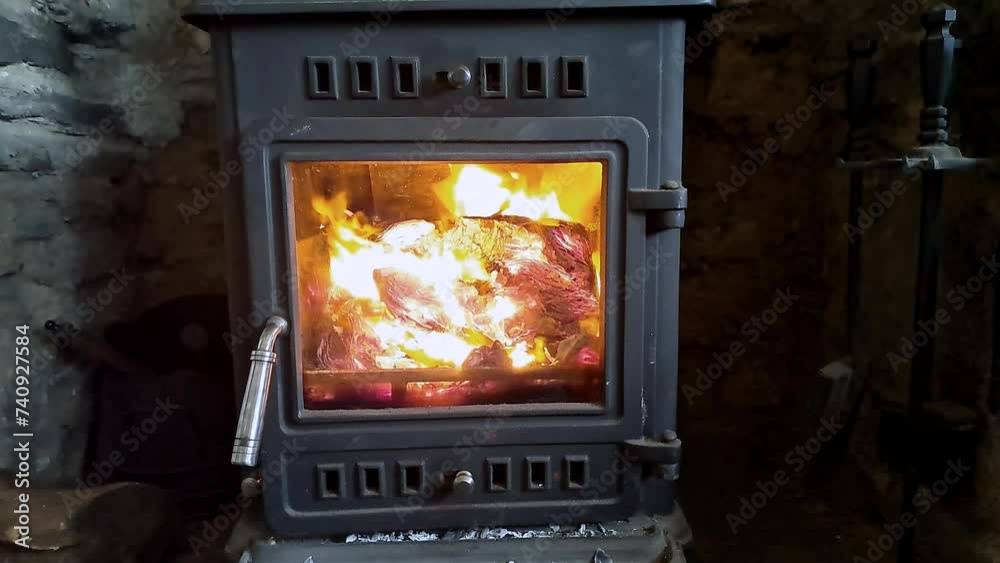 Overview of a fire inside a log burning stove with lots of flames and ...