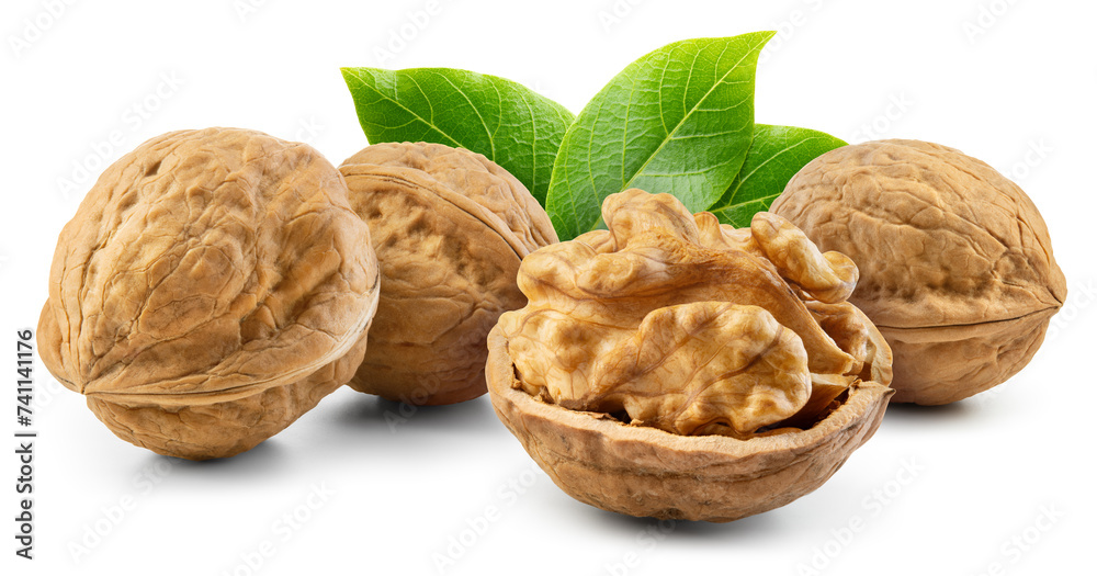 Walnut isolated. Unpeeled walnuts with a nut half and leaves on white ...