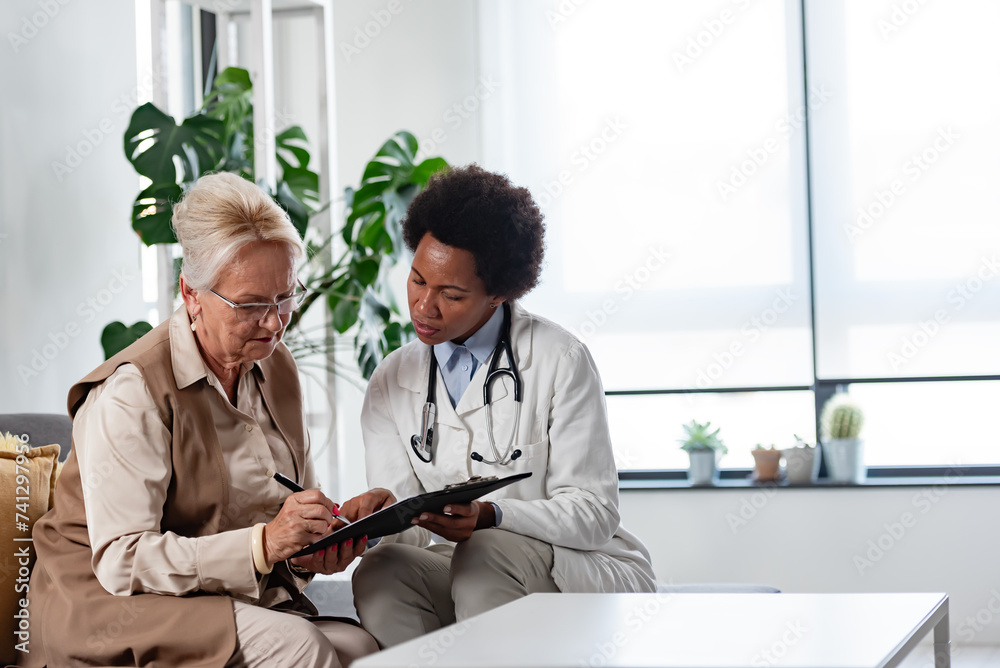 Doctor specialist consulting a patient at the clinic. A female doctor ...