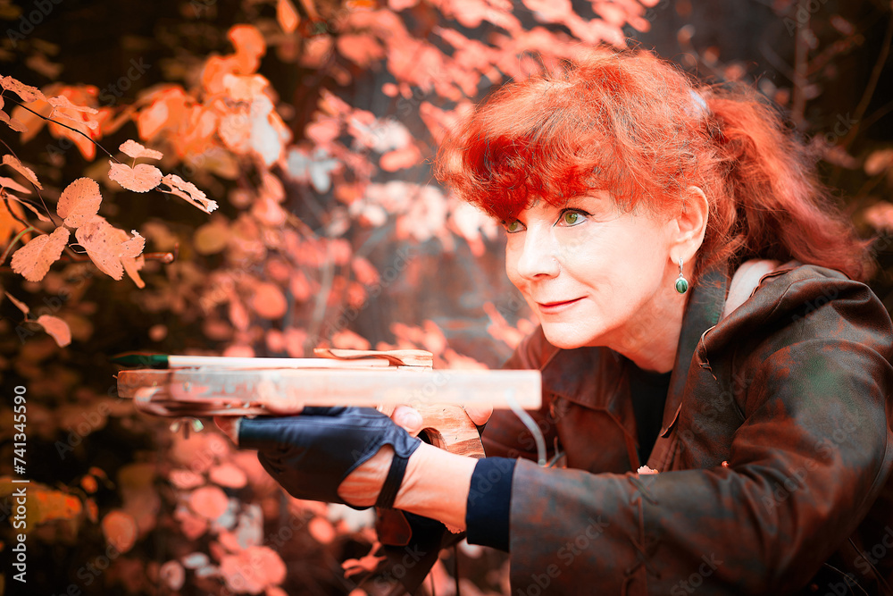 Mature model portraying a royal huntress with red curve hair is hunting ...