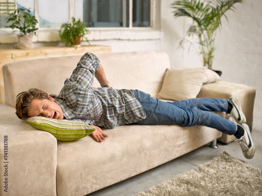 Back pain, stress and screaming man on a sofa with emergency, problem ...