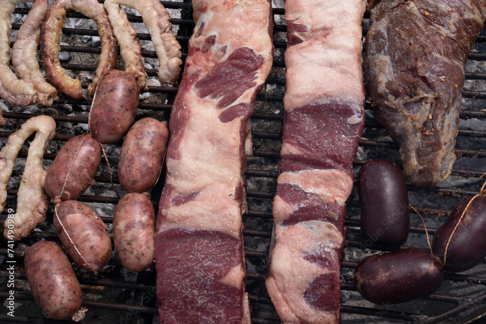 Barbecue. Roasting meat, pork sausages, blood sausages and chitterlings ...