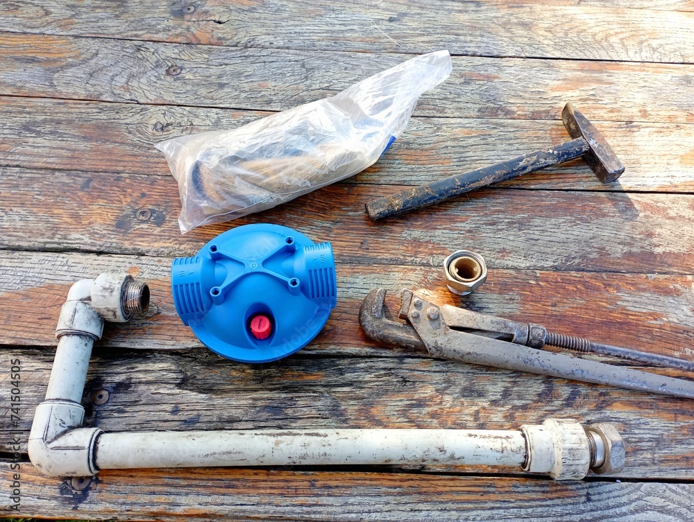Tools and spare parts for replacing the water filter are laid out on ...
