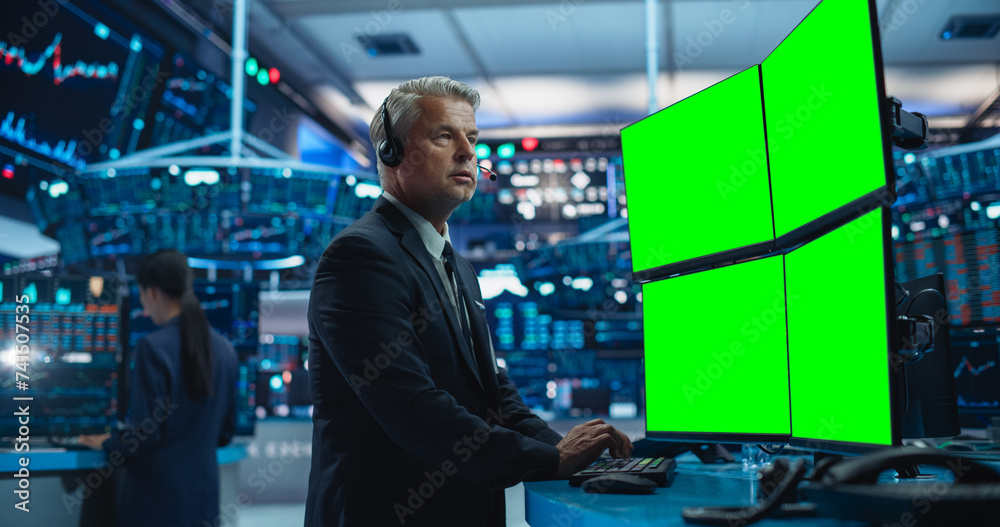 Adult Stock Exchange Broker Working on a Desktop Computer with Green ...