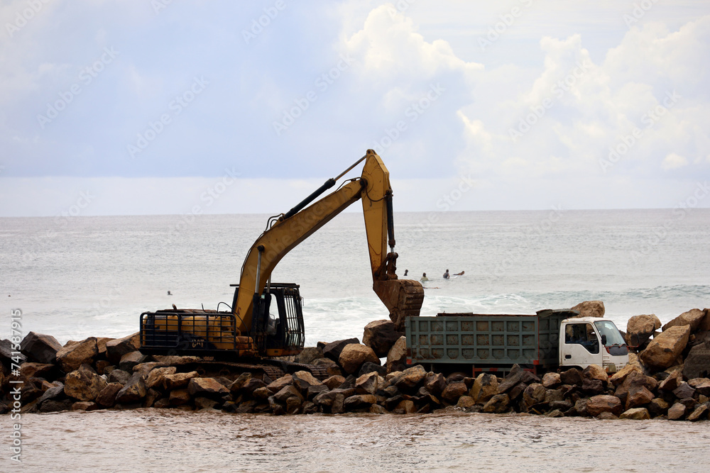 filling land in the sea, or land reclamation. construction of ...