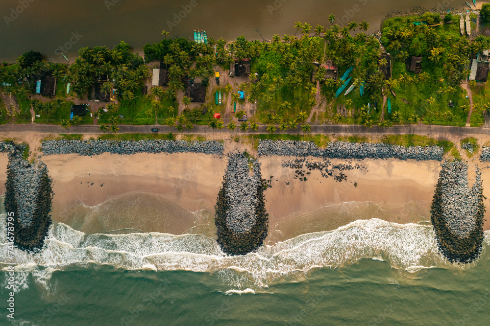 Aerial view of breakwater along a strip of land with Pithrody beach and ...