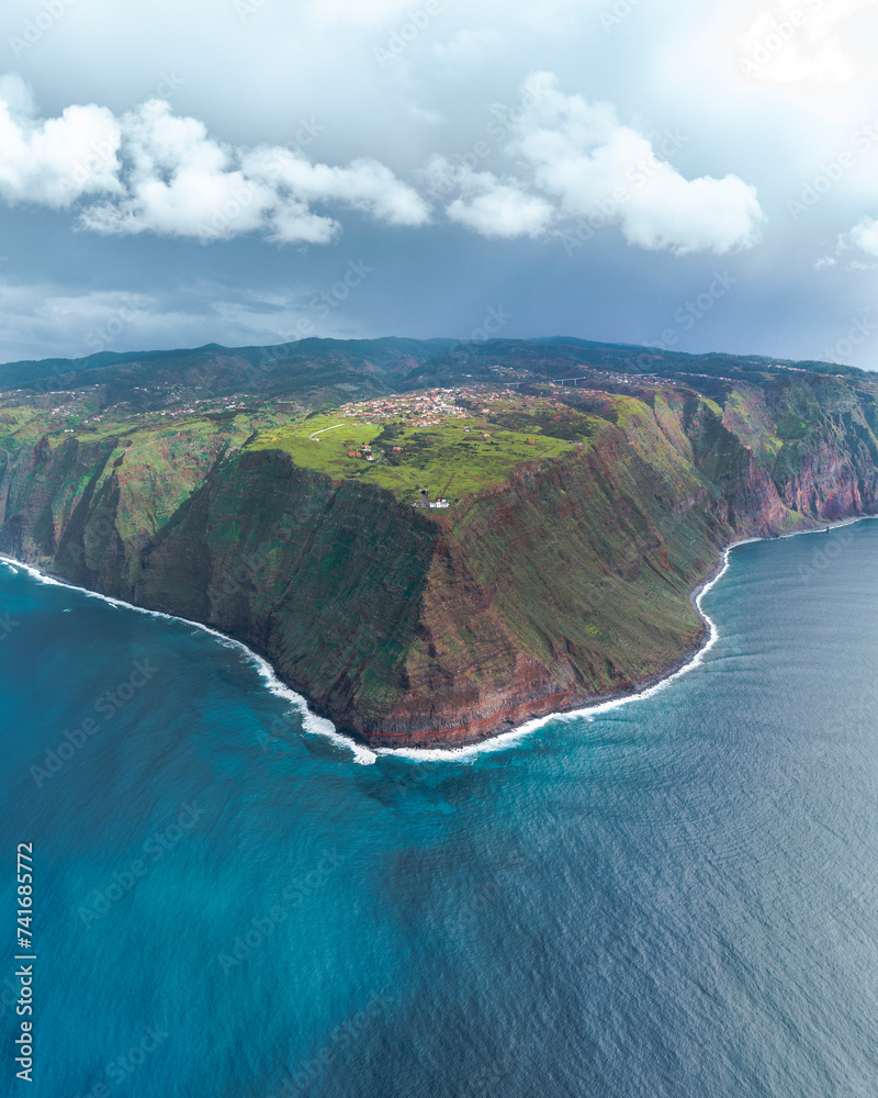 Aerial drone view of Madeira coastline, lighthouse and cliffs from ...