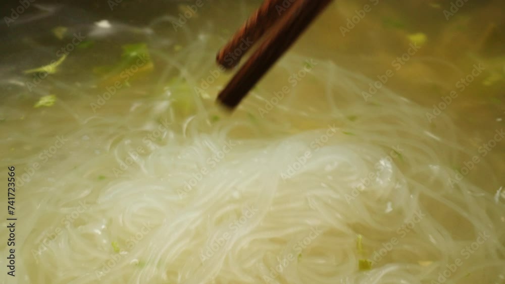 Cooking instant Funchoza noodles texture.noodles in boiling water with ...