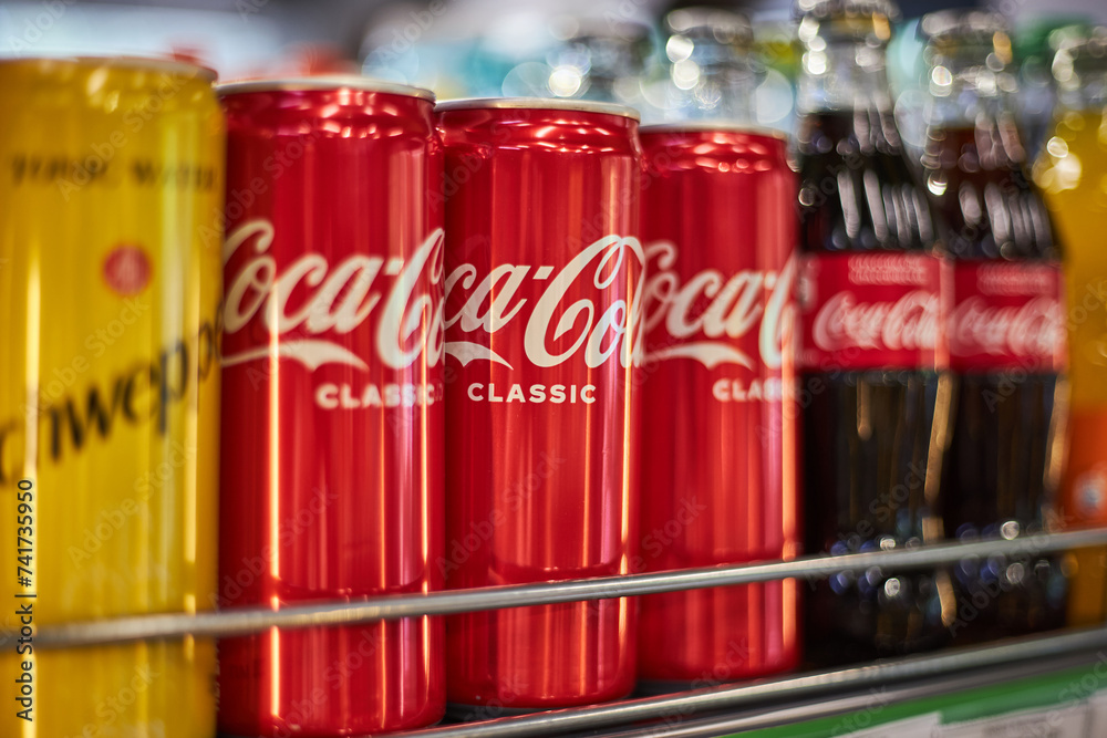 Shelf in store with soda of different brands. Coca Cola, schweppes ...