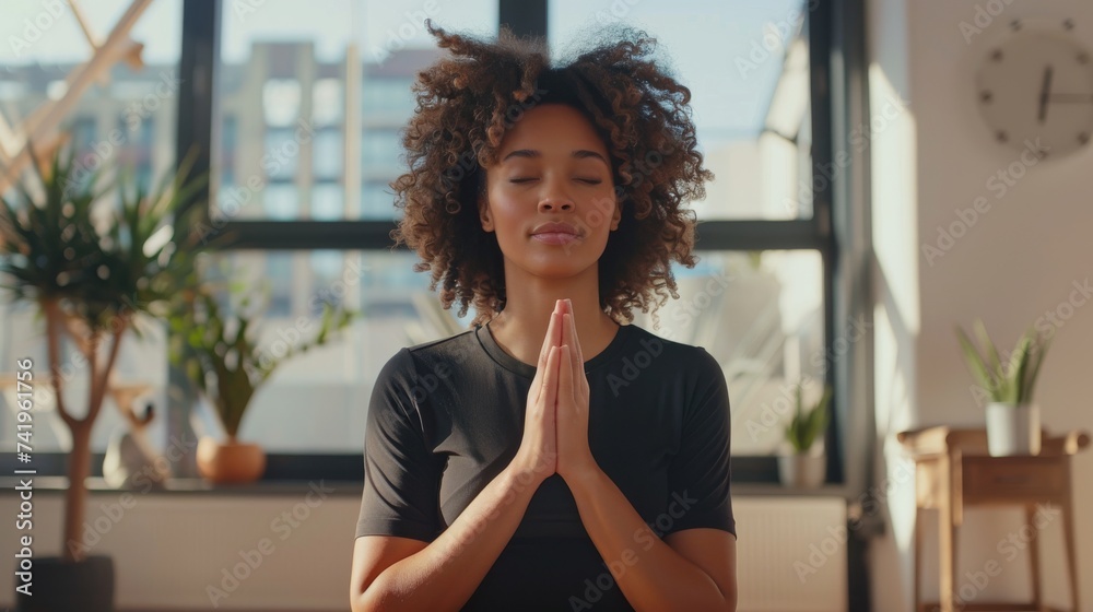 A woman finds peace and serenity in her indoor oasis, surrounded by ...