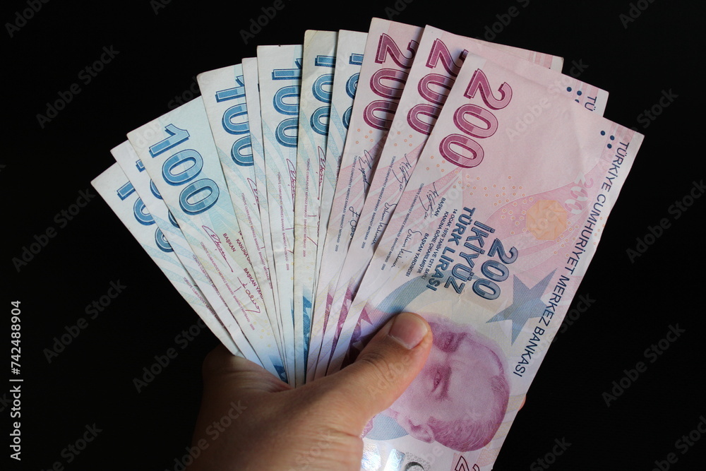 man counting Turkish money with his hand. Turkish lira banknotes. The ...