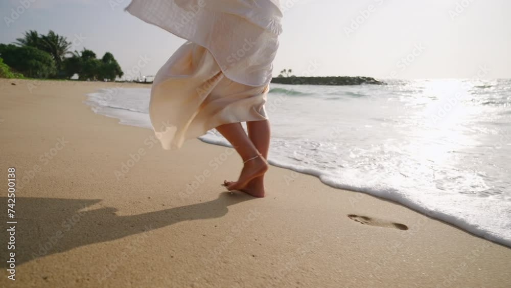 Female feet walking barefoot, leaving footprints on sand at seaside ...