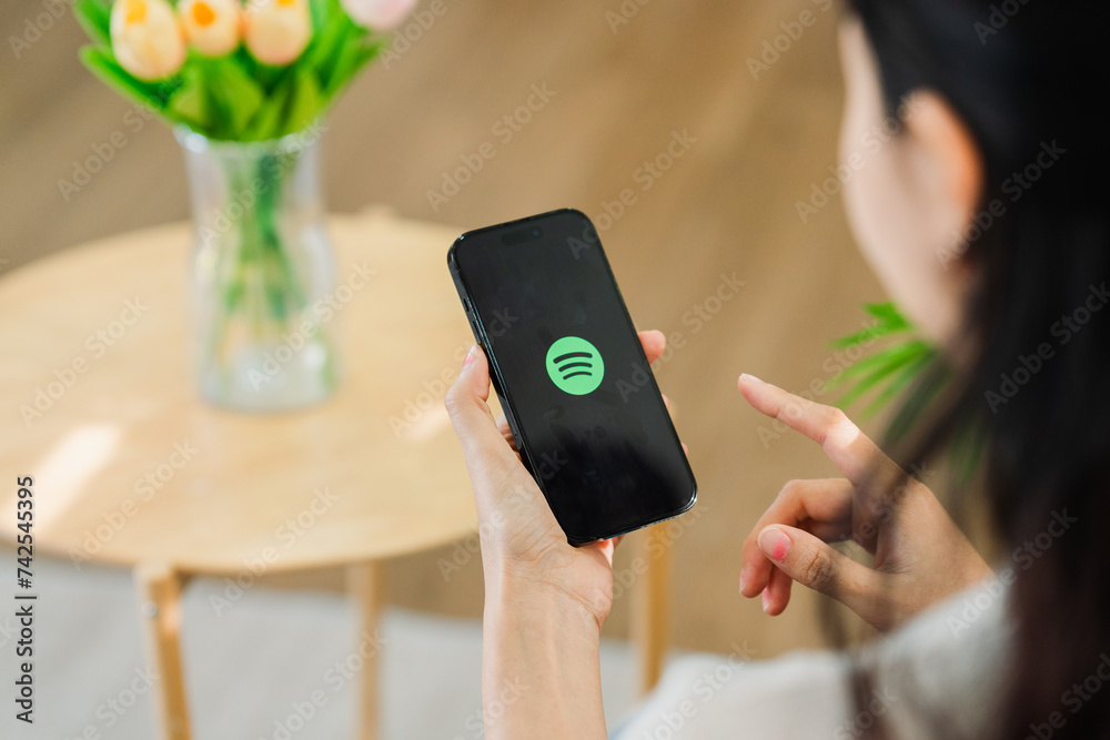 Chiang Mai, Thailand - Feb 22 2024: A female using Spotify application ...