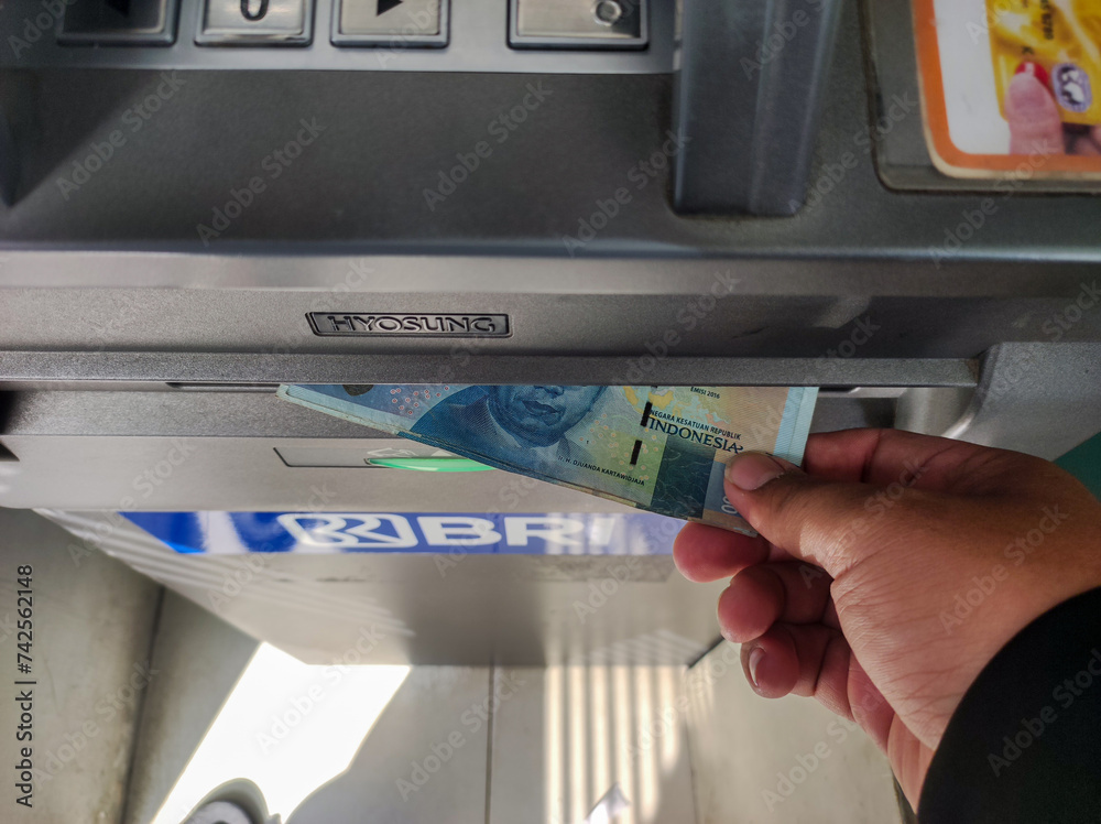 50,000 rupiah of Indonesian currency came out of an ATM machine ...