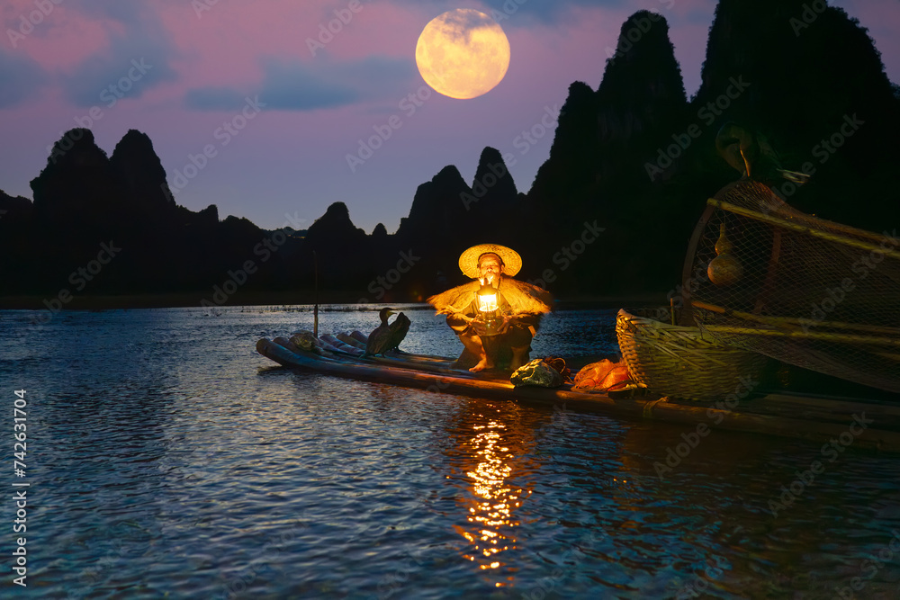 Traditional Chinese old senior Cormorant Fisherman on his wooden ...