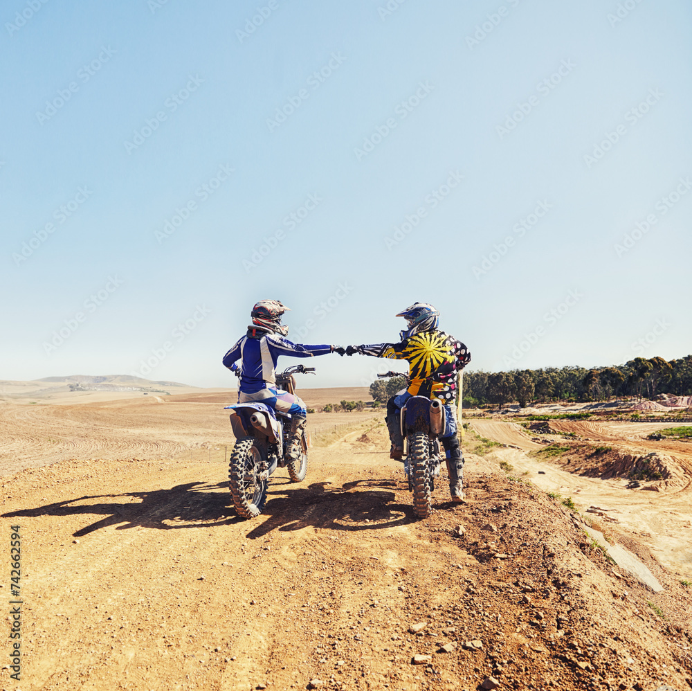 Sport, teamwork or people on motorcycle outdoor on dirt road before ...