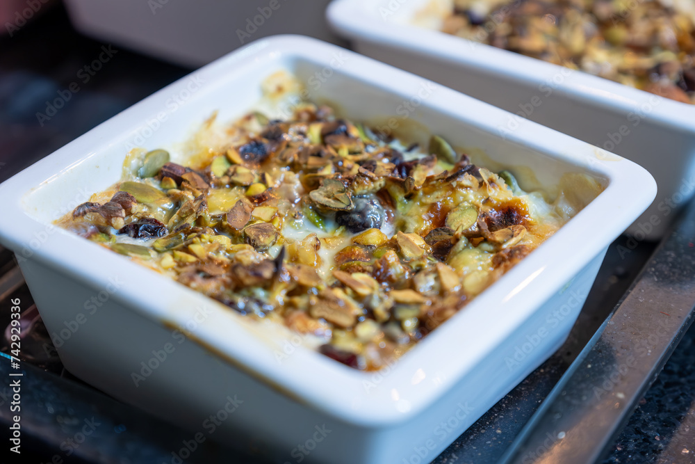 um ali is arabic sweet that made of puff pastry and nuts with milk and ...