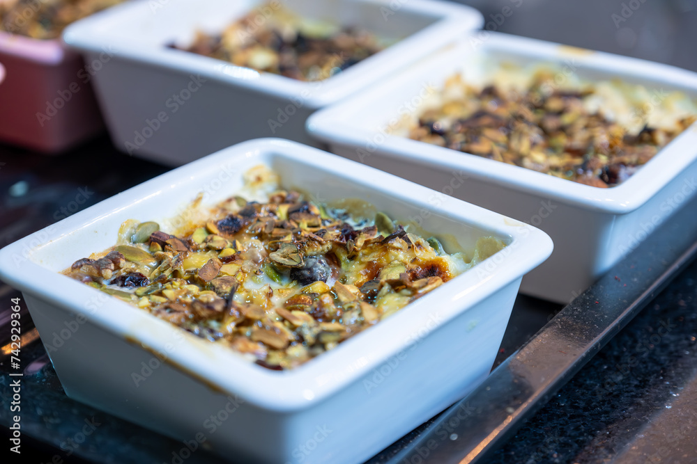 um ali is arabic sweet that made of puff pastry and nuts with milk and ...