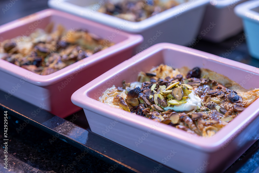 um ali is arabic sweet that made of puff pastry and nuts with milk and ...