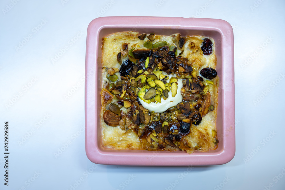 um ali is arabic sweet that made of puff pastry and nuts with milk and ...