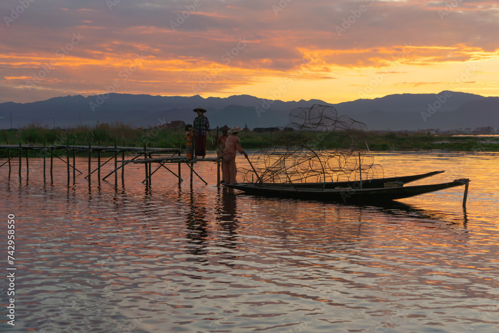 Burmese fisherman casting or throwing a net for catching freshwater ...