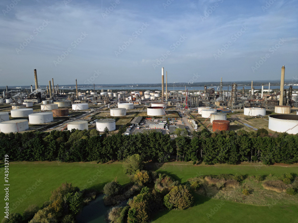 UK oil refinery and green belt in Fawley aerial view. White oil storage ...