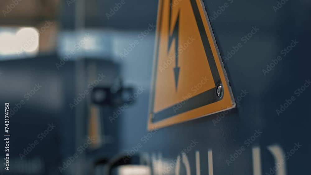 Installation of a high voltage warning sign at the entrance of an ...