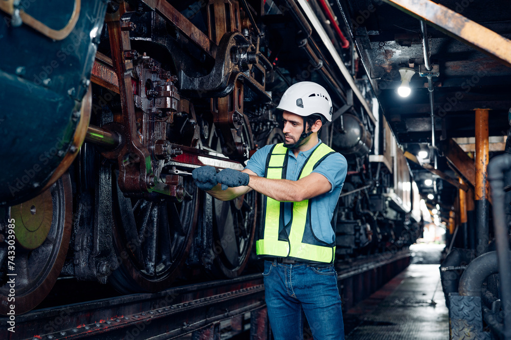 Male engineer maintenance locomotive engine wearing safety uniform ...