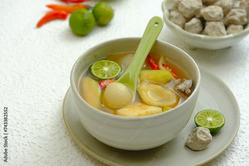 A bowl of Asinan Kiamboy on white background.. Fruits pickle with ...