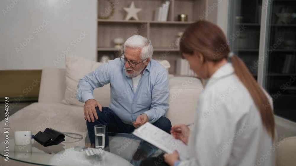 Senior man therapist consults woman. Medical appointment to young ...