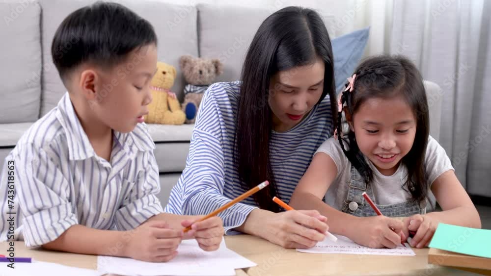 Asian female teacher teaching assignments for primary school children ...