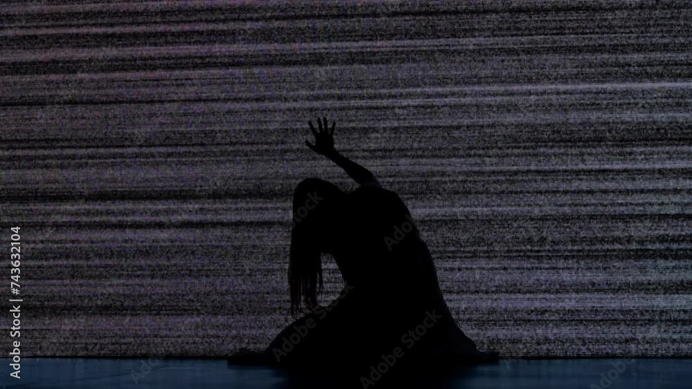 Silhouette against digital television screen. Thriller scene scared ...