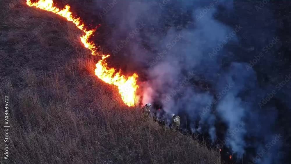 grassland fire burning aerial video. firefighters suppressing fast ...
