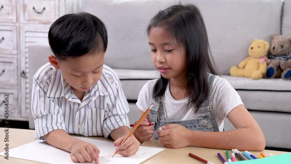 Happy sibling brother and sister laughing playing drawing together at ...
