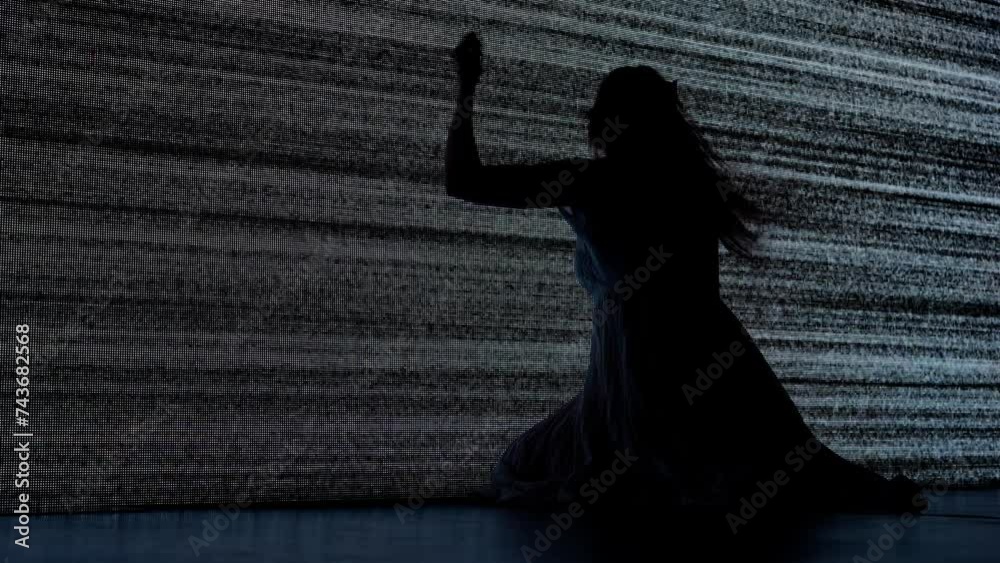 Silhouette against digital television screen. Thriller scene scared ...