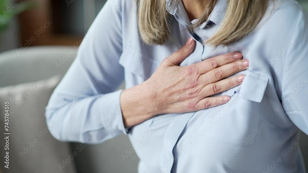 Close up. Senior woman's hand holds massaging chest. Sick elderly woman ...