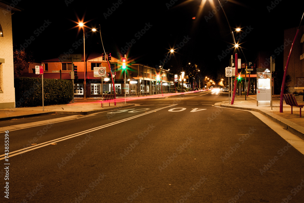 Red orange and green traffic lights in a small town at night Stock ...
