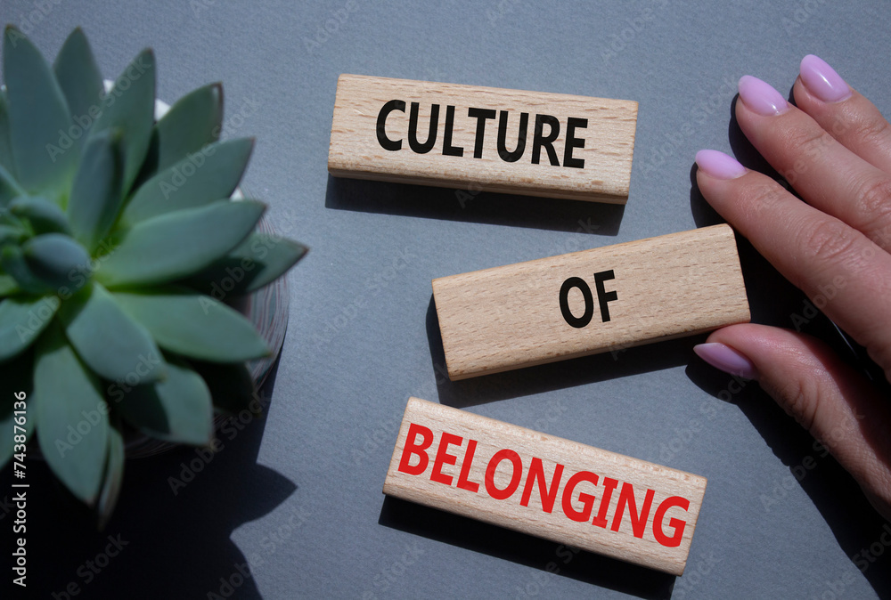 Culture of Belonging symbol. Wooden blocks with words Culture of Belonging. Beautiful grey ...