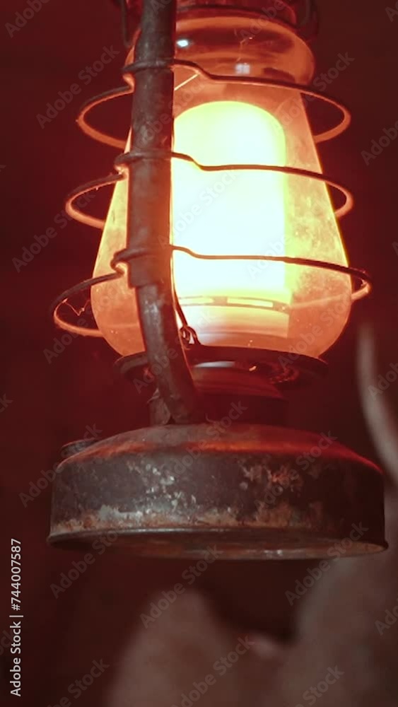 Deer antlers hang on the wall with an ax and other metal weapons in the ...